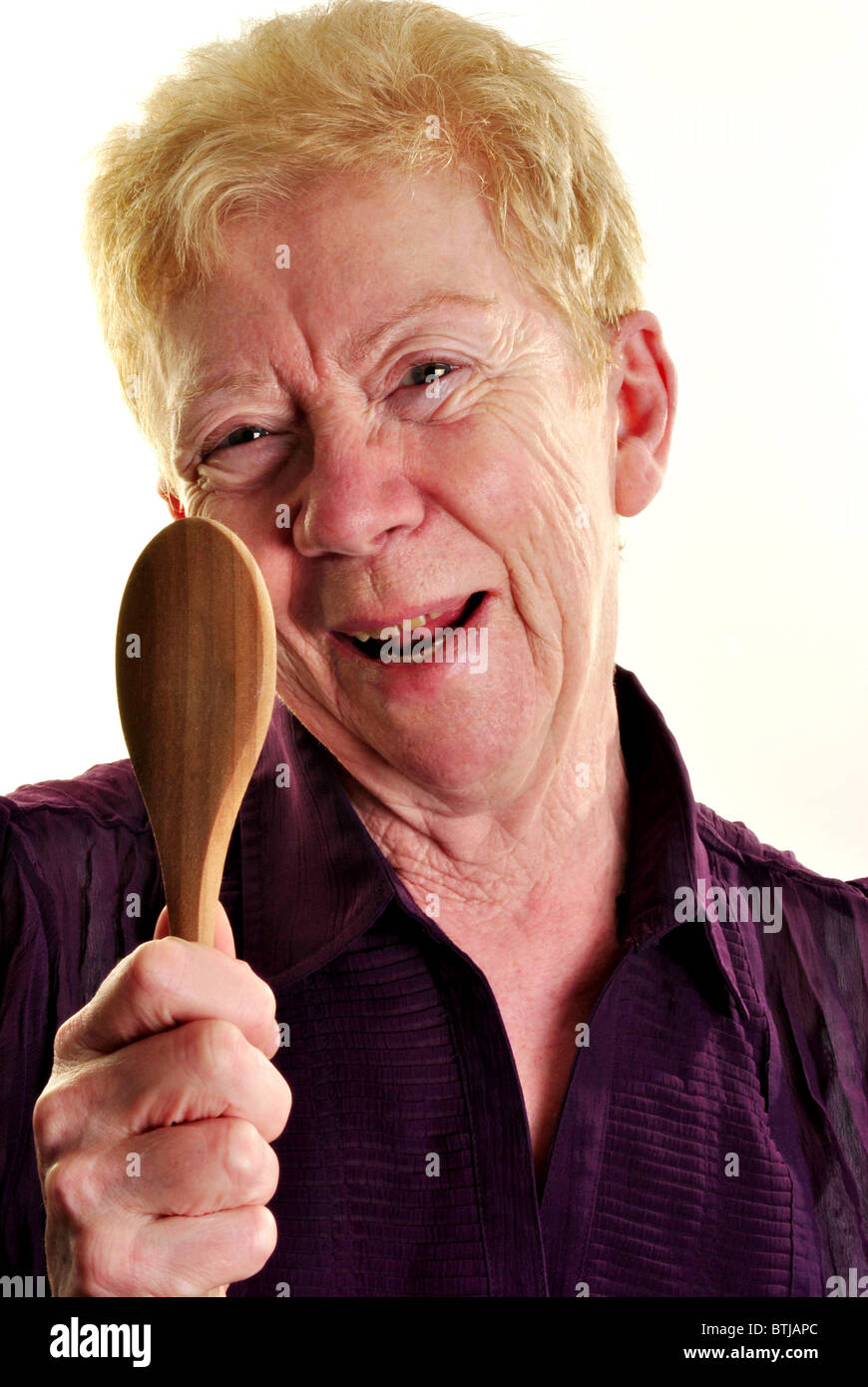 an old age woman is holding a cooking spoon Stock Photo - Alamy