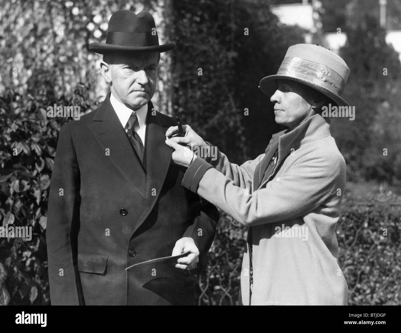 First Lady Grace Coolidge pins a Red Cross button on President Calvin ...