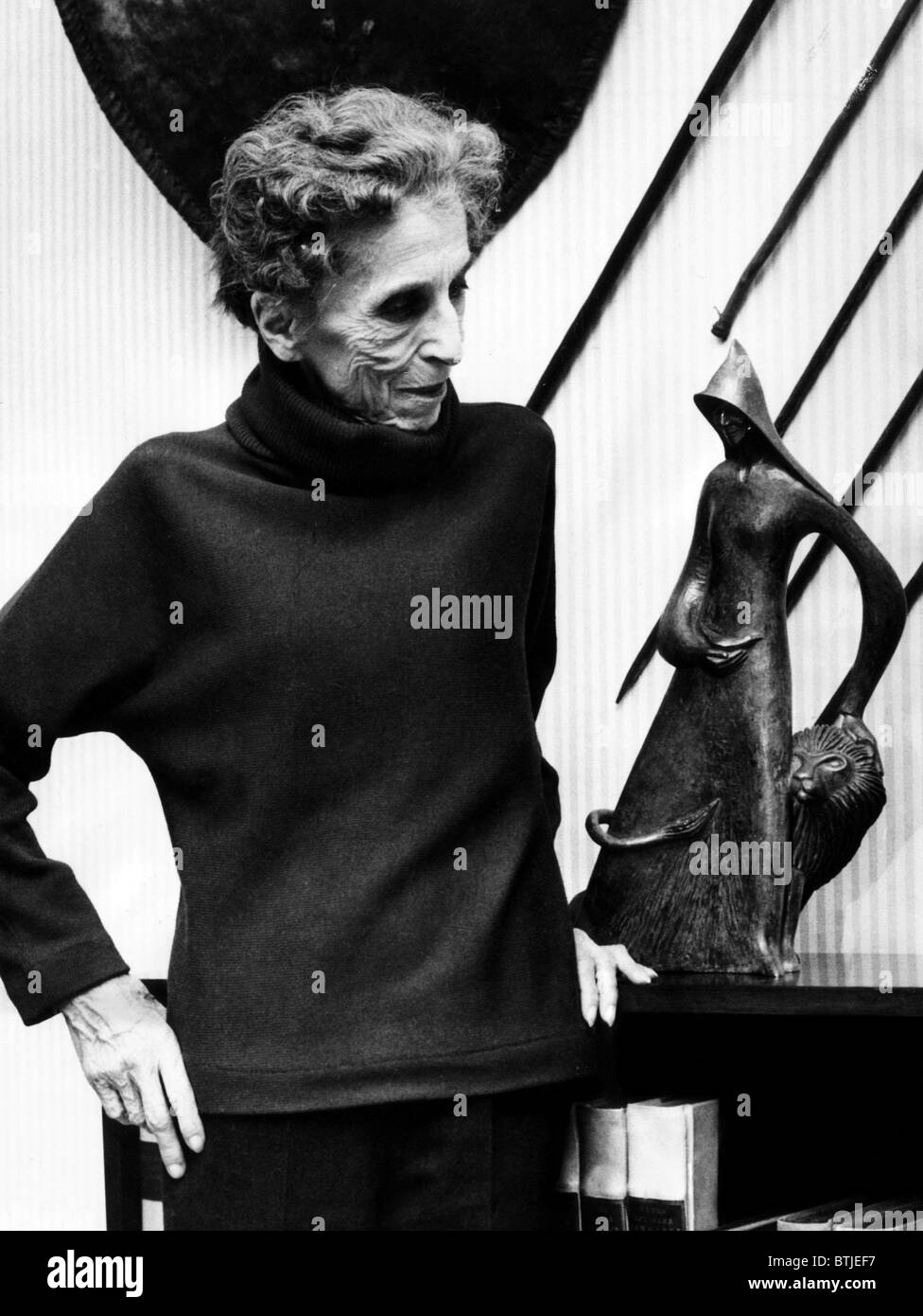 Isak Dinesen looks at a sculpture of herself made by Emile Norman, 1961 ...