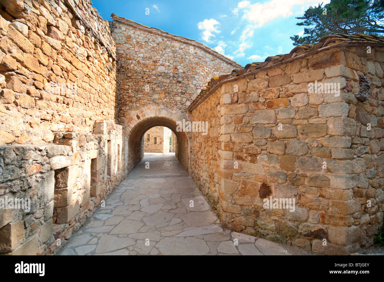Old passageway in medieval town of Peratallada, Spain in sunny summer ...