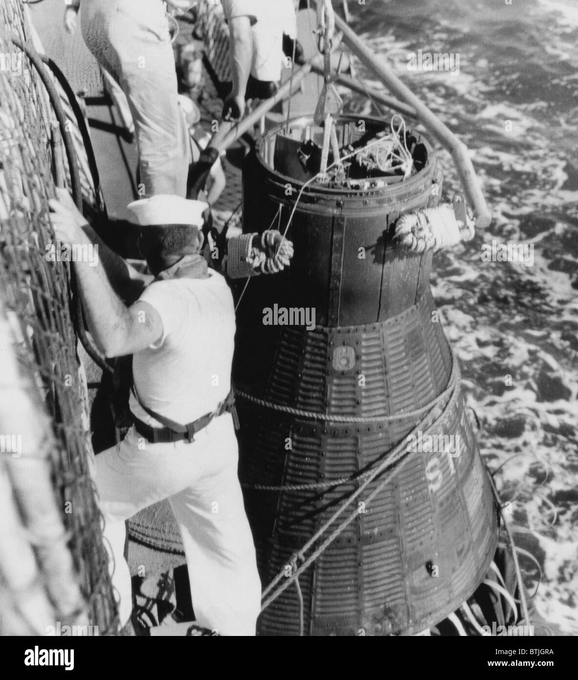 The US Navy waits for astronaut John Glenn, to emerge from the ...