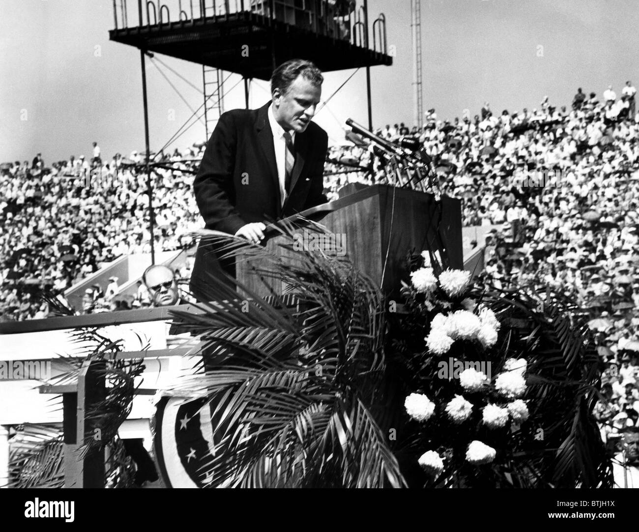 Evangelist, Billy Graham preaching to a crowd at the Chicago Crusade ...