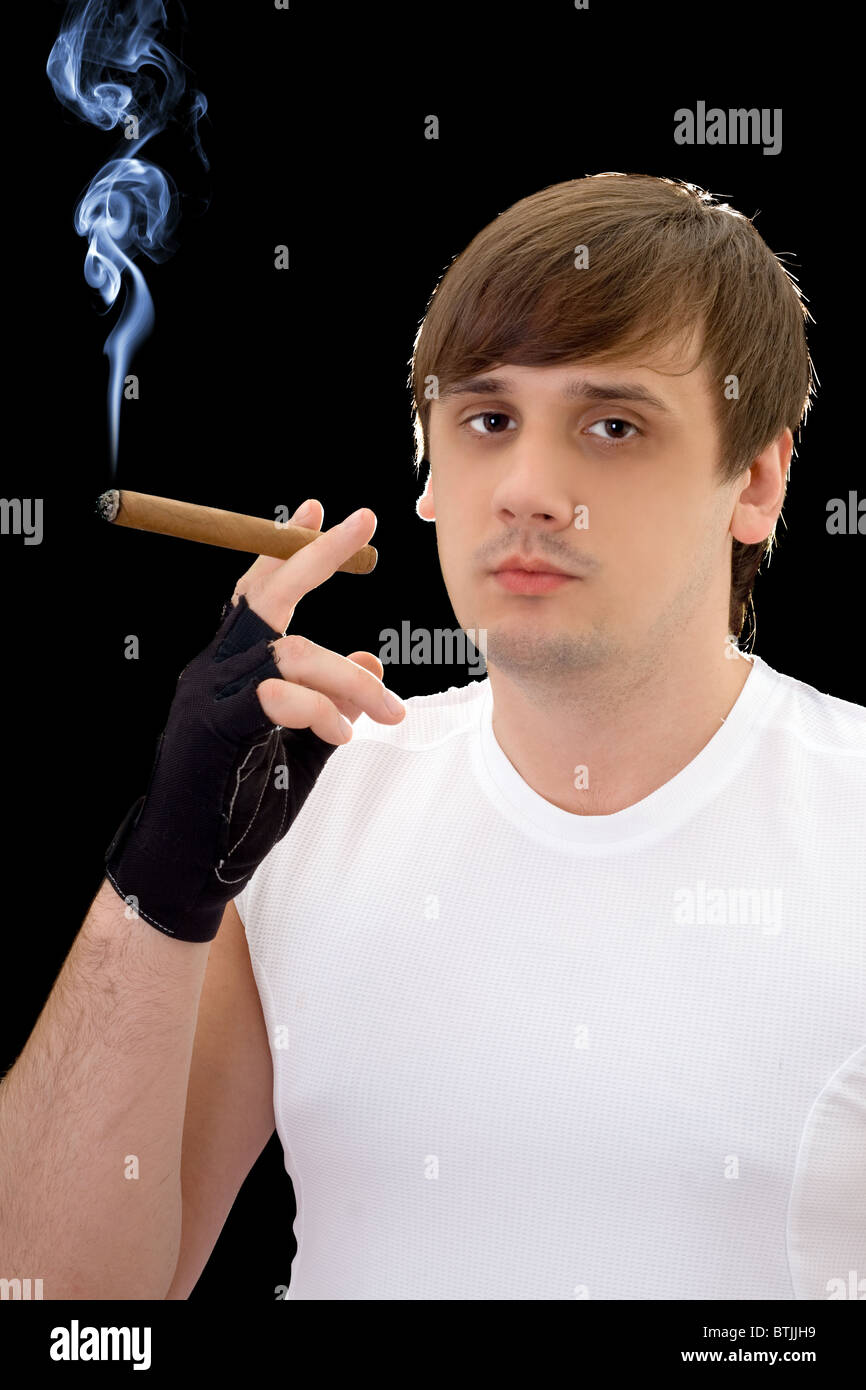 Young man with cigar. Isolated on black Stock Photo - Alamy