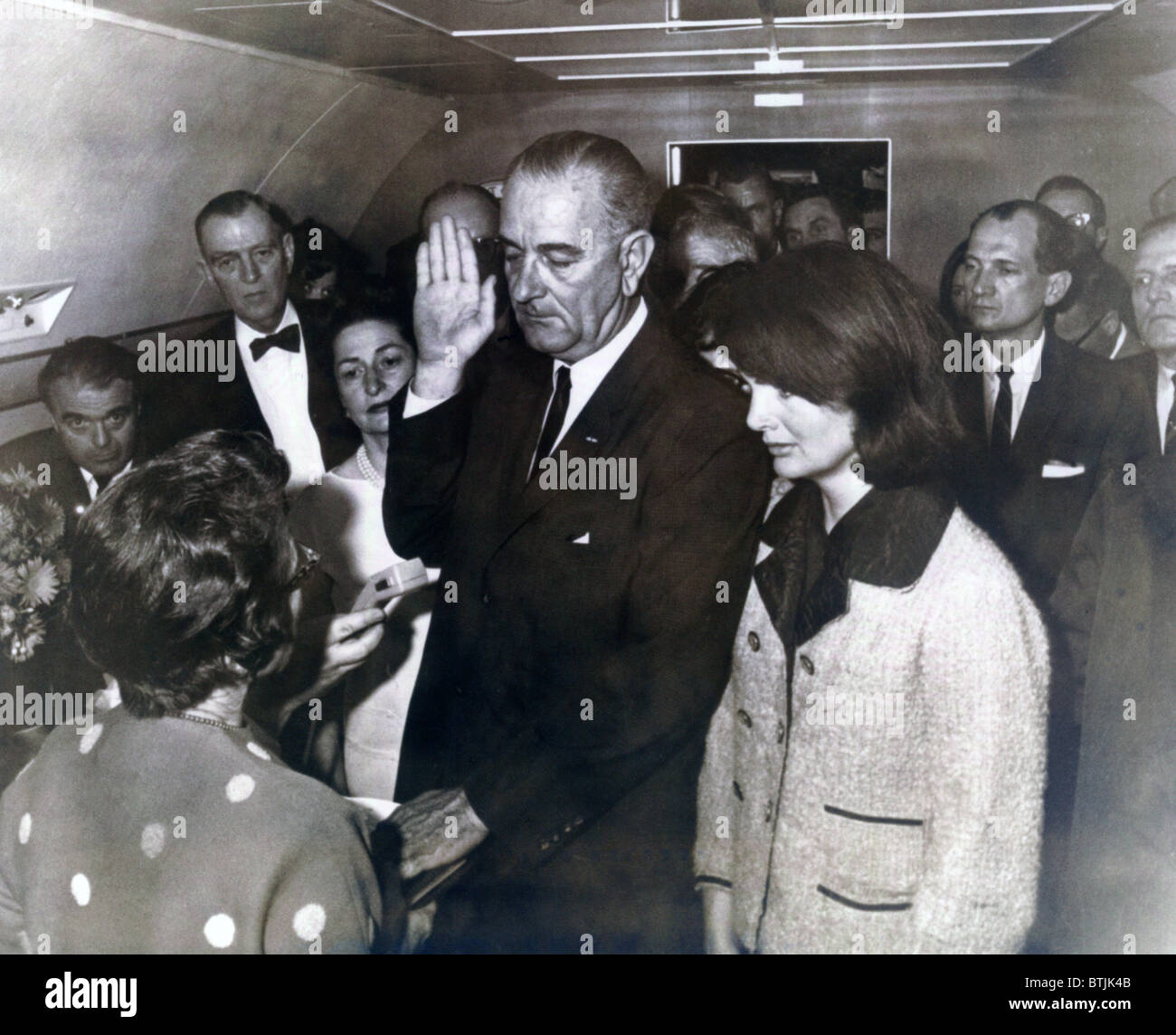 Johnson taking oath. Ladybird Johnson and former first lady Jacqueline ...