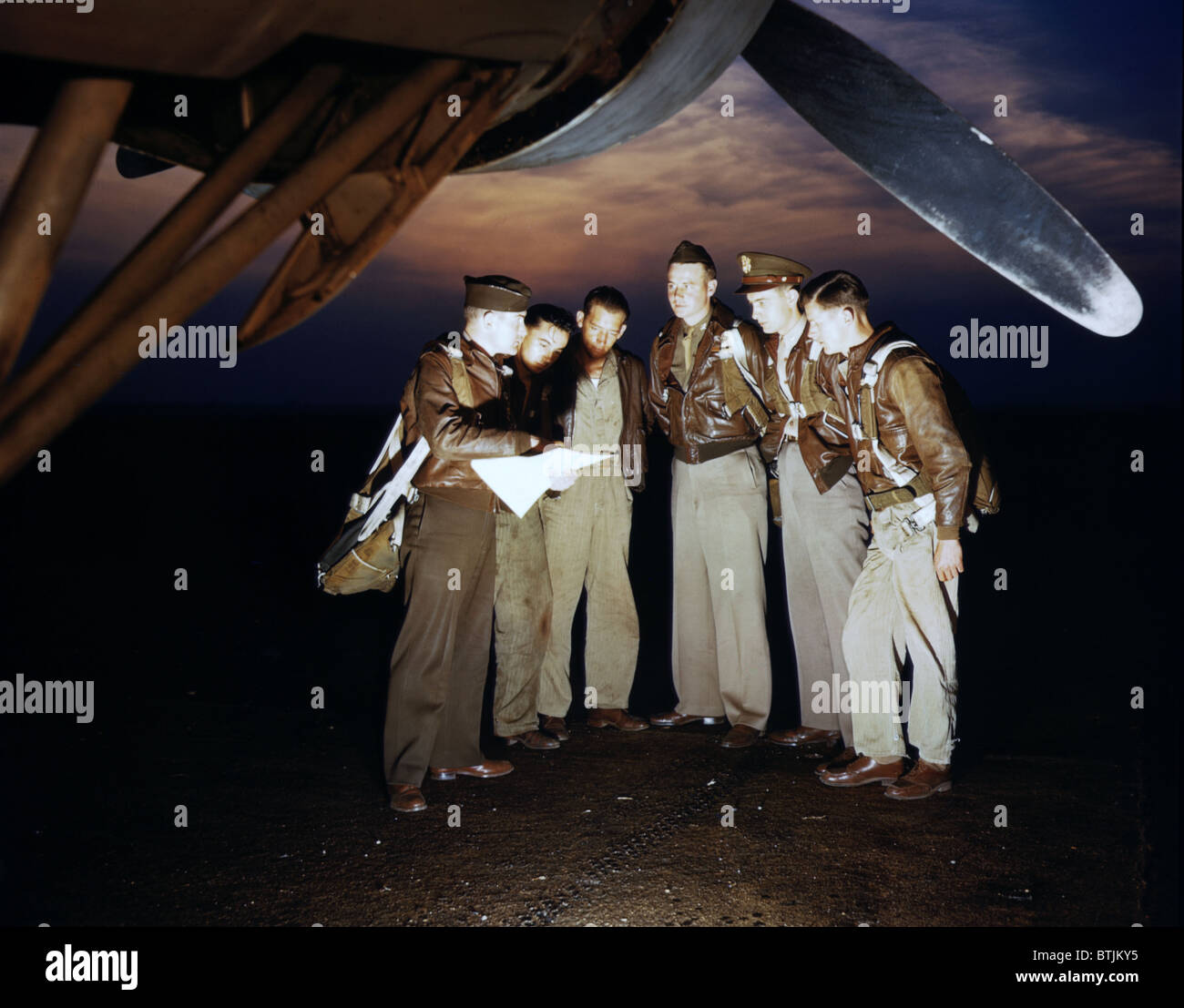 A combat crew receives final instructions just before taking off in a ...