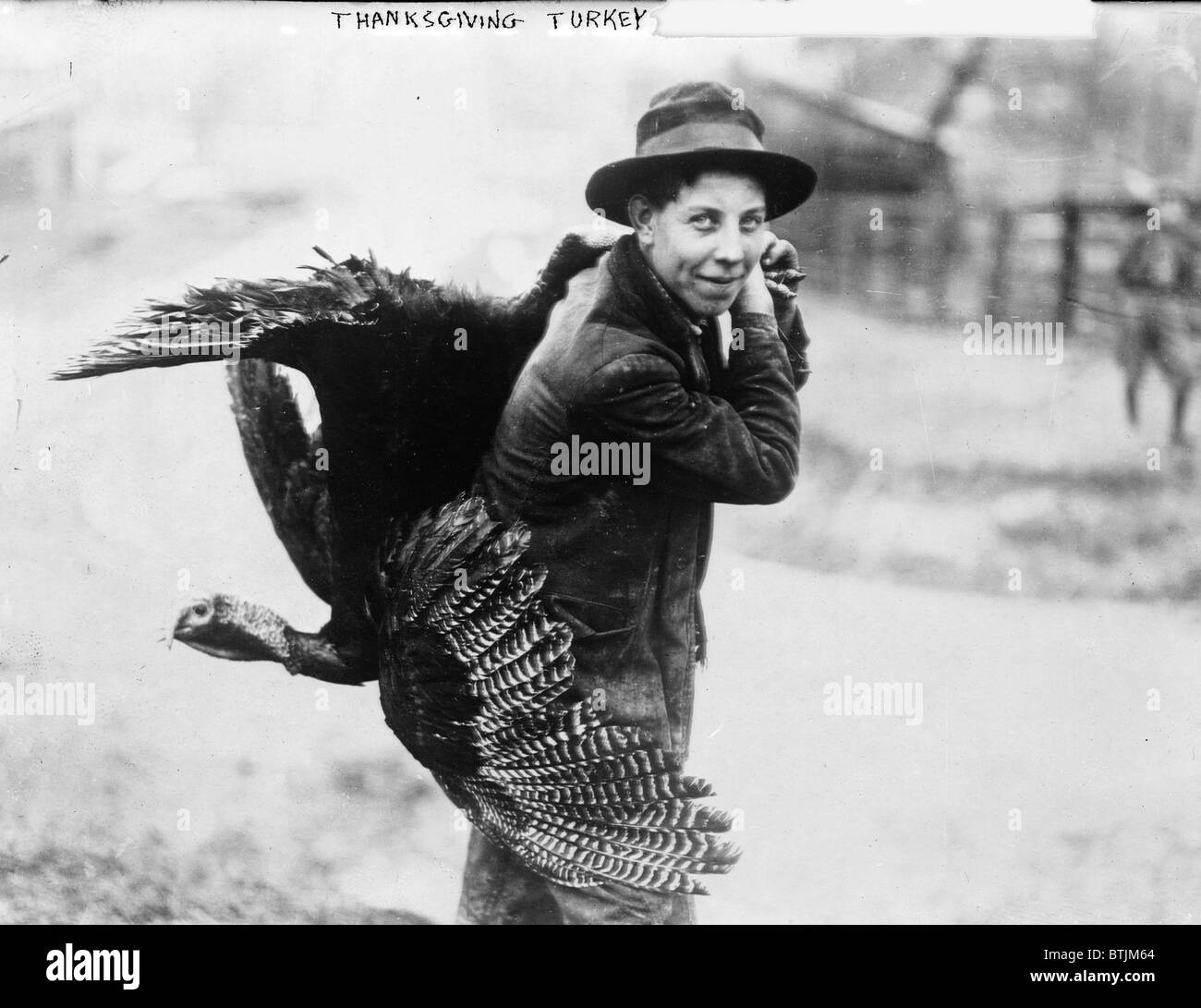 Young man with Thanksgiving turkey, circa 1910s Stock Photo - Alamy
