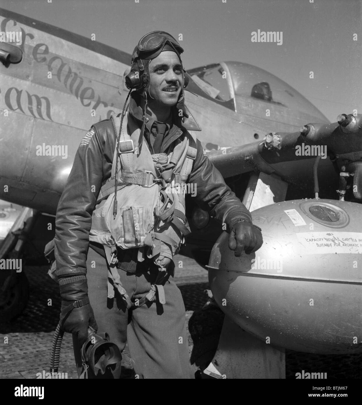 A Tuskegee fighter pilot poses with his P-51D Mustang, Ramitelli, Italy ...