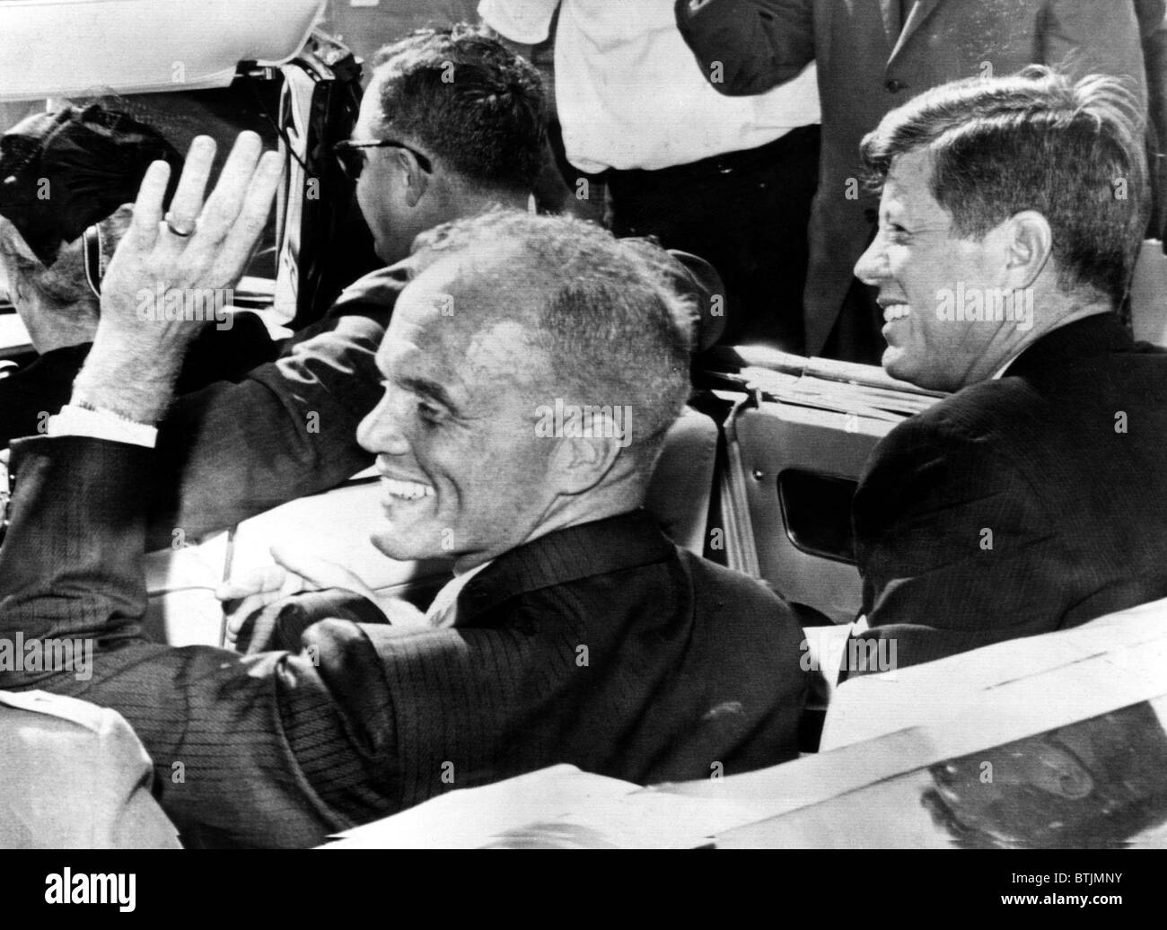 Astronaut John Glenn and President John F. Kennedy wave and smile to a ...