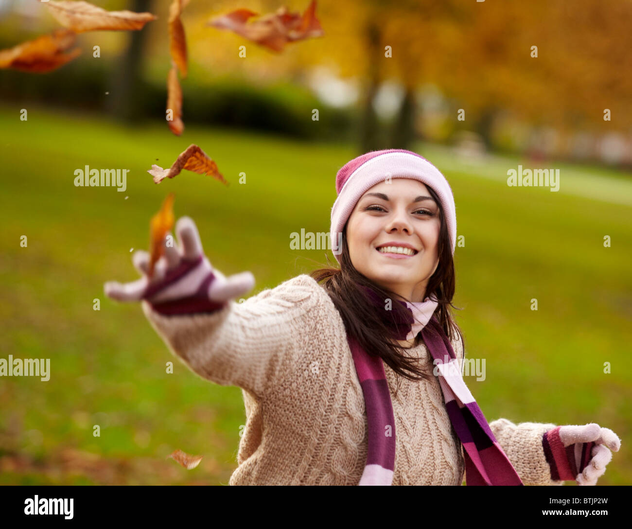 Brunette girl collecting Autumn leaves Stock Photo - Alamy