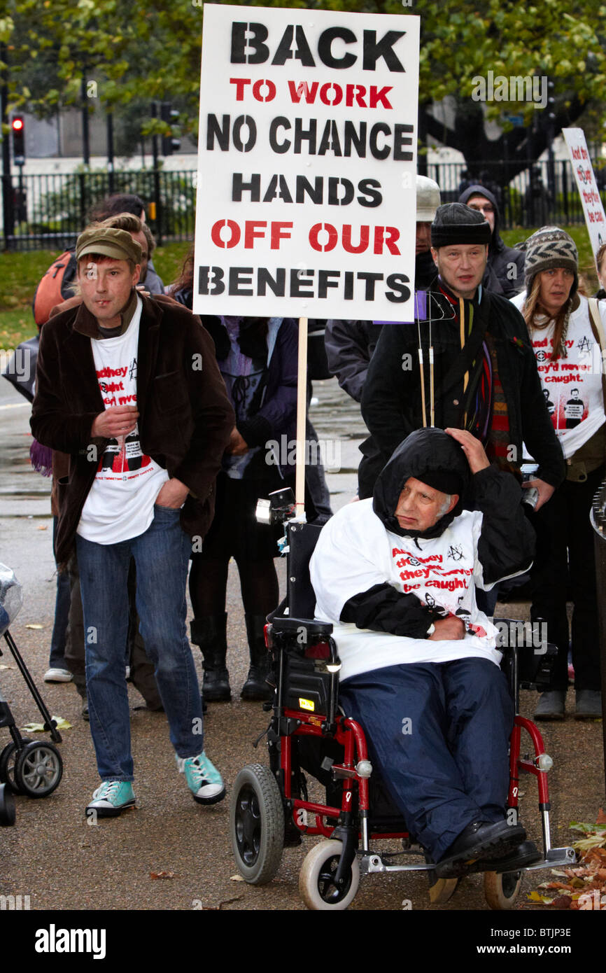 LONDON, UK. Protesters, one in a wheelchair, hold placards during a ...