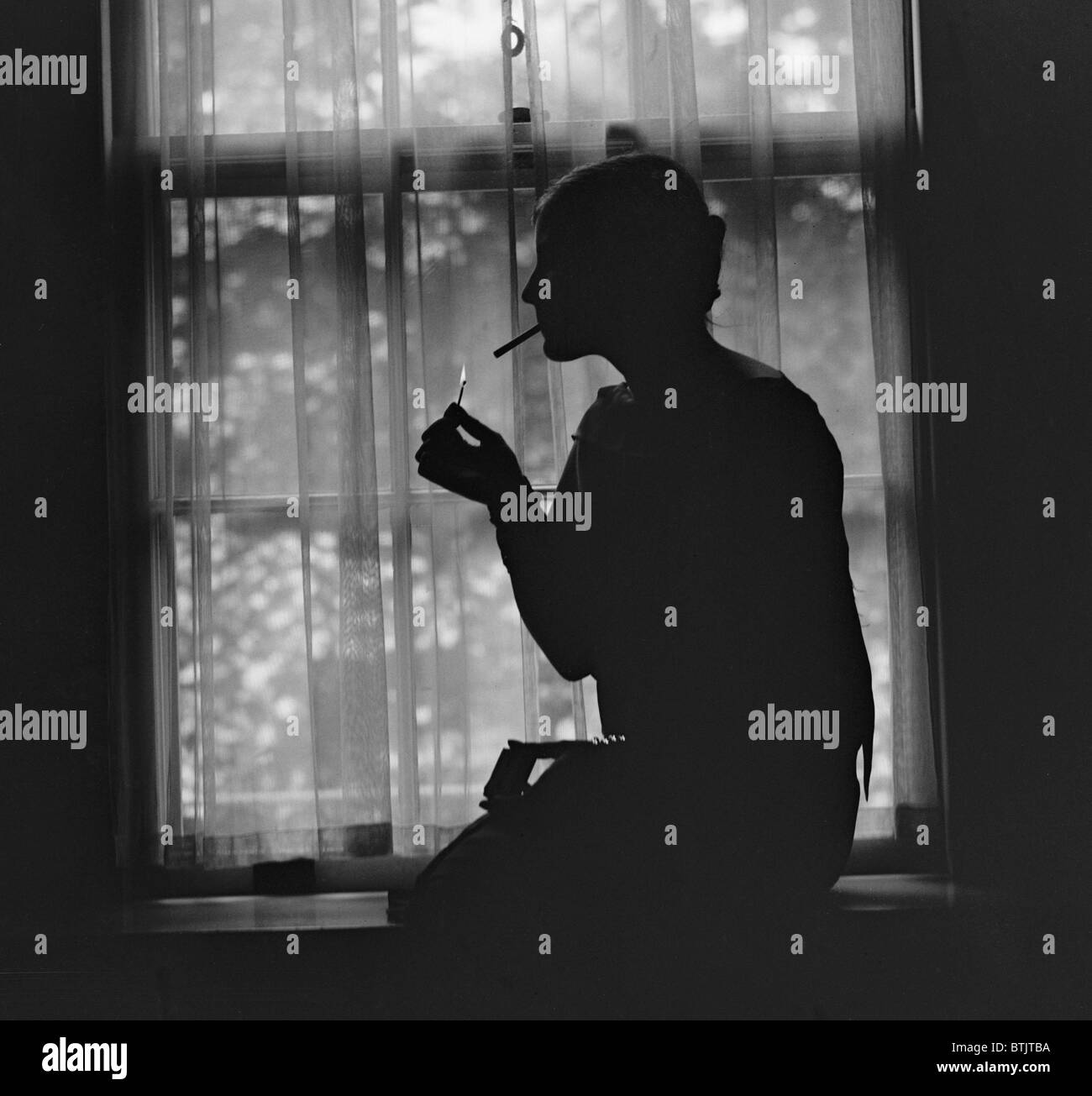 Silhouette of a stylish women smoking in 1926. During the 1920s, many ...