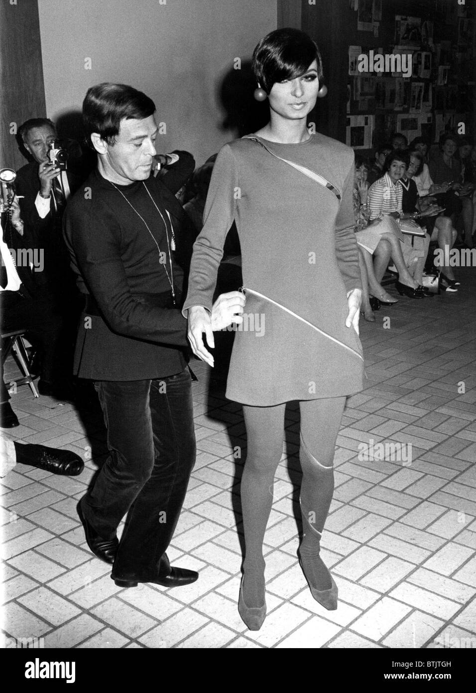 Rudi Gernreich dressing a model at a New York fashion show, 5/23/68 ...