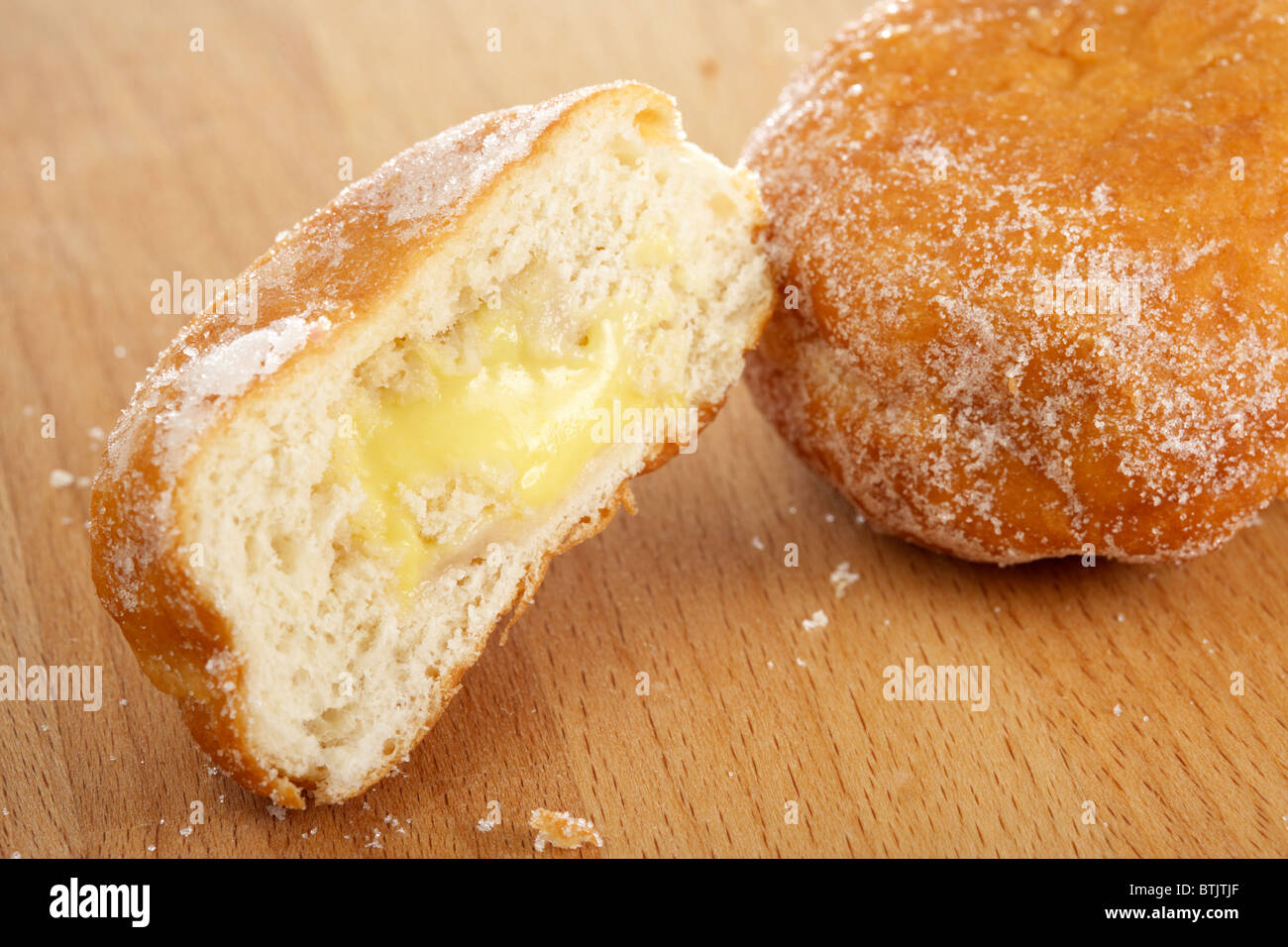 cut sliced custard flavoured filled doughnut Stock Photo - Alamy