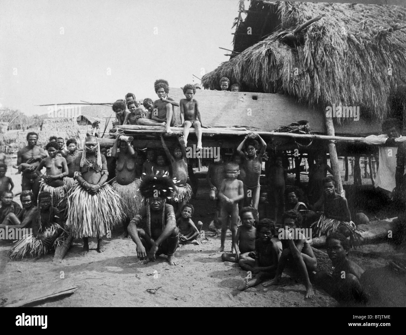 Group of Tongans in traditional costume pose in front of village ...