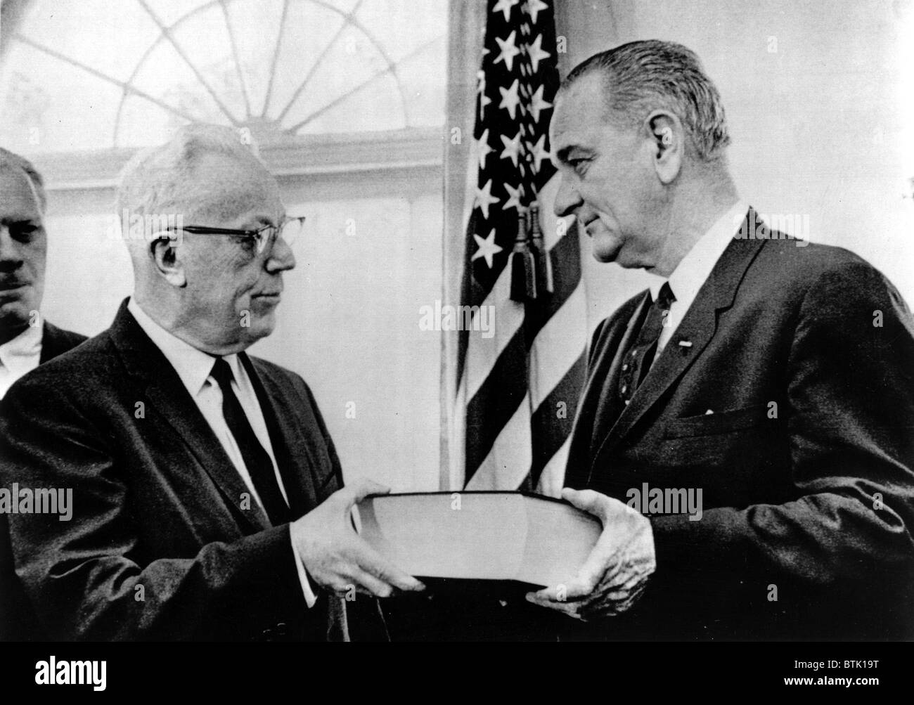 Gerald Ford (far left) looks on as Chief Justice Earl Warren presents ...