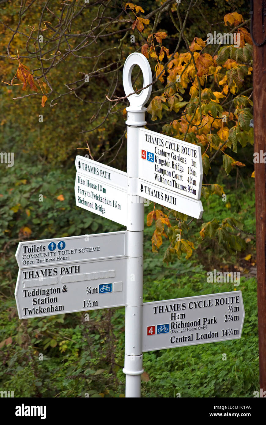 signpost by teddington lock on the river thames with local directions ...