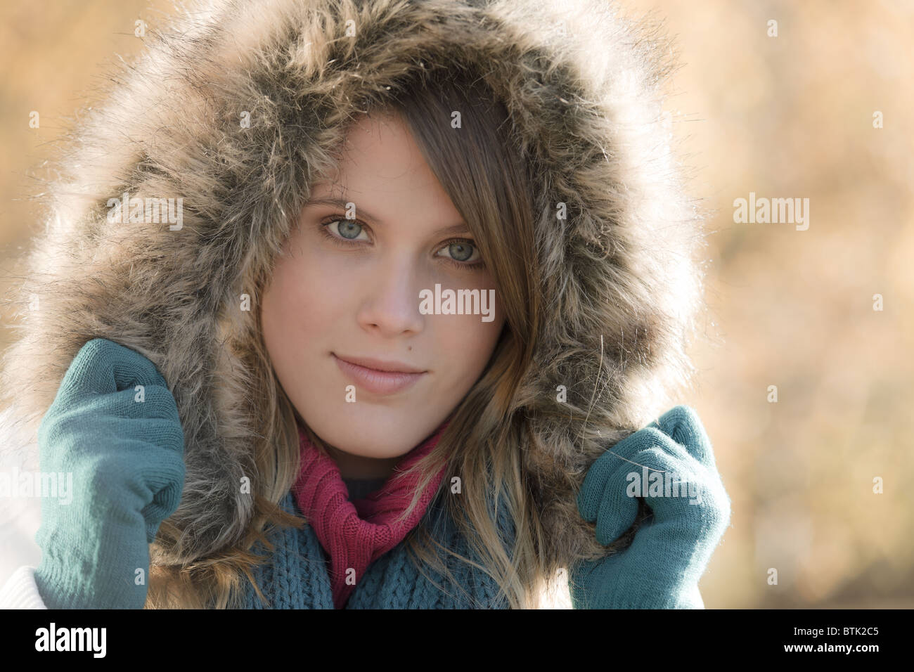 Winter fashion - woman with fur hood and gloves outside, desaturated ...