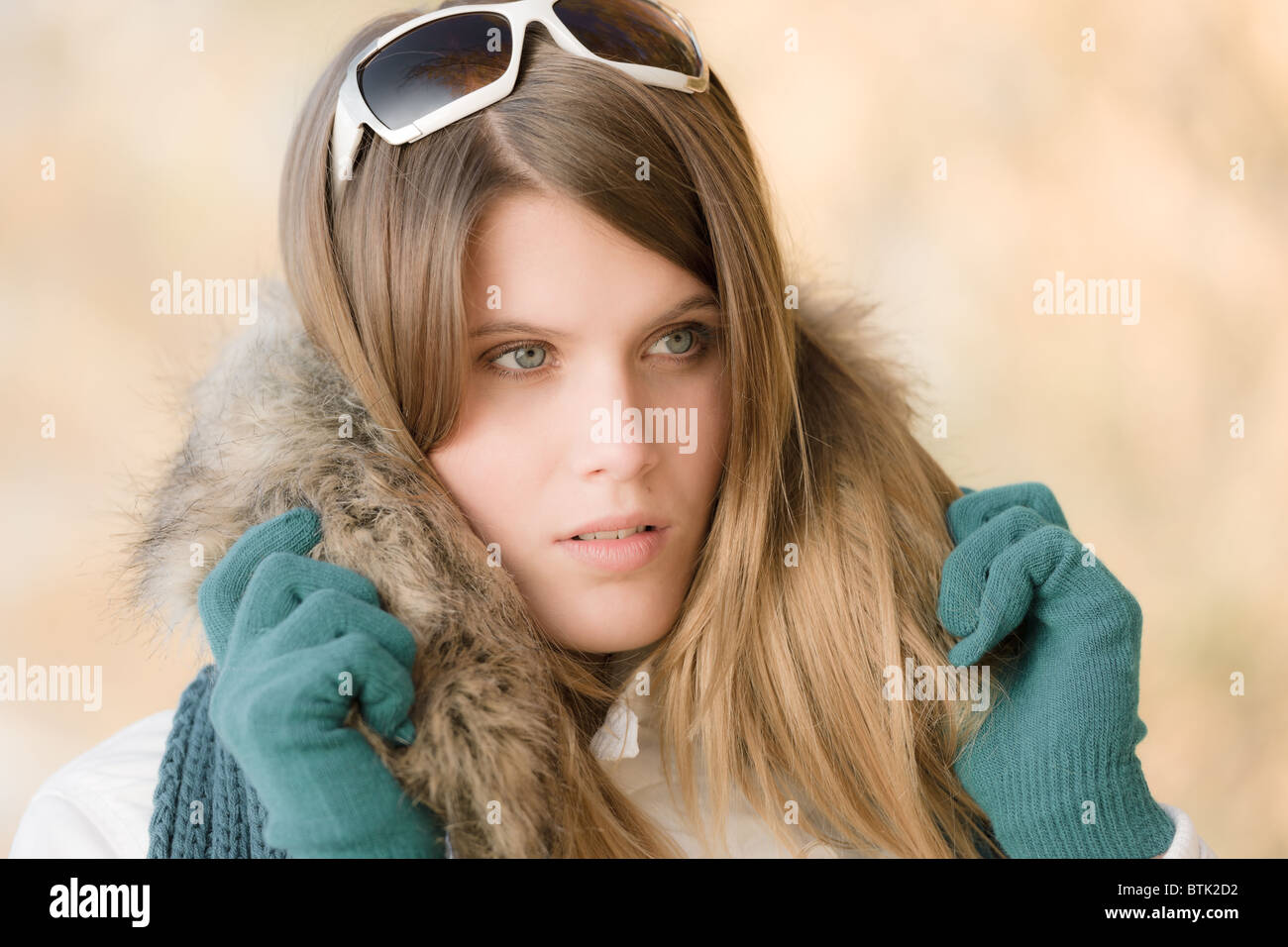 Winter fashion - woman with fur hood and gloves outside, desaturated ...