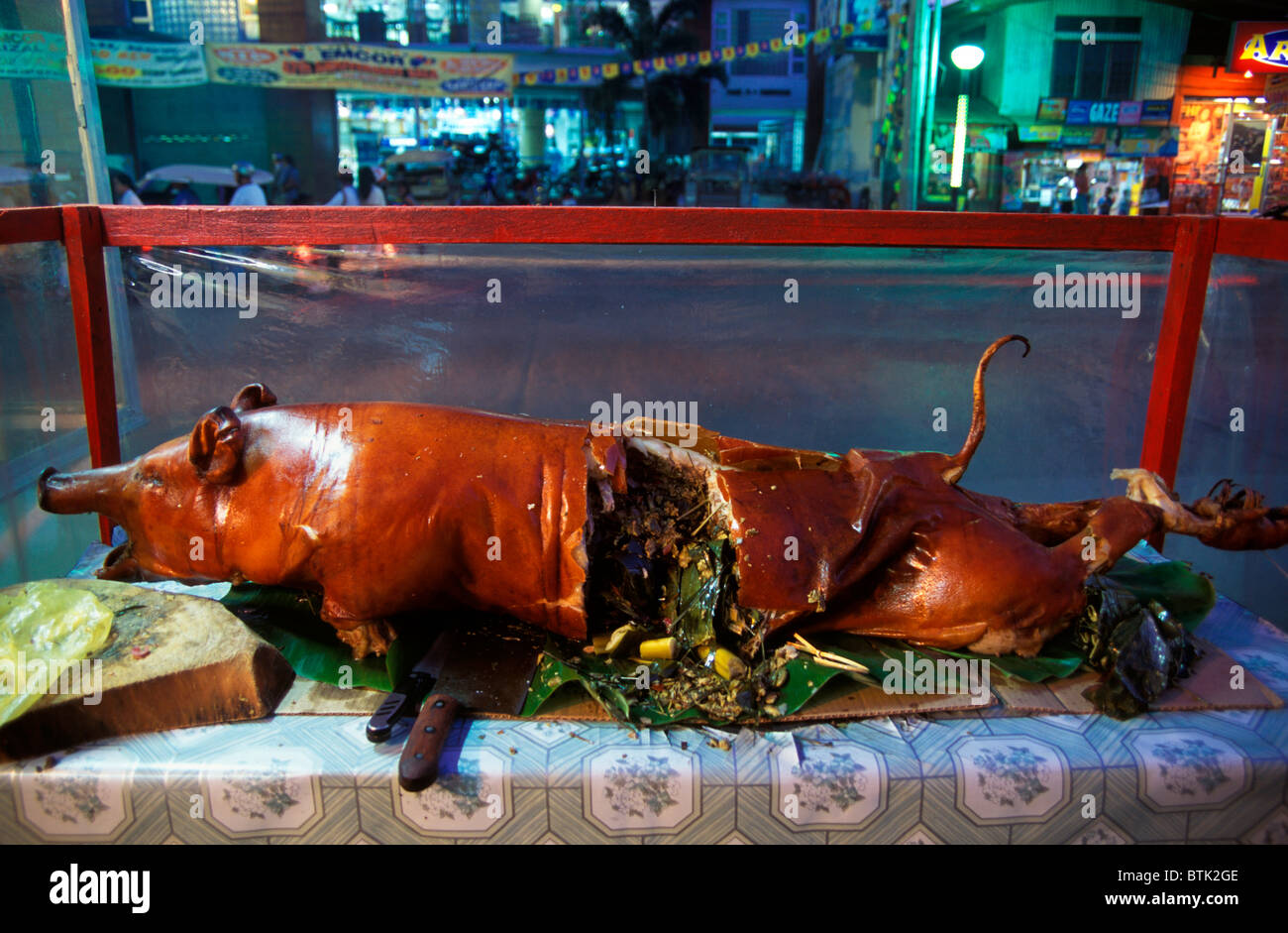 A whole suckling pig stuffed with herbs and roasted, then sold from ...