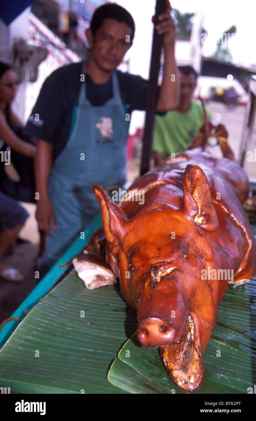A whole suckling pig stuffed with herbs and roasted, then sold from ...