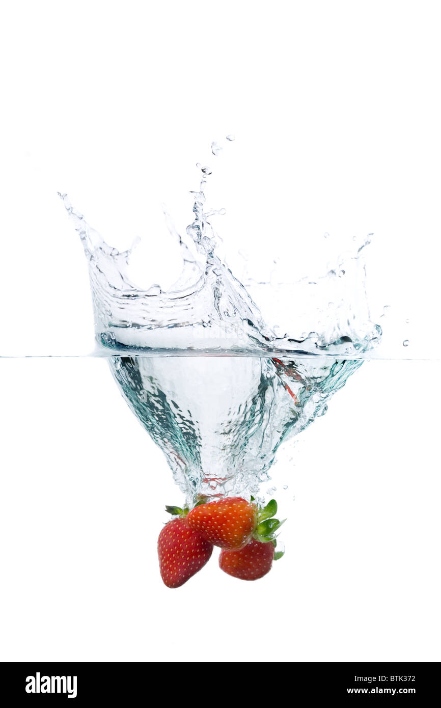 Three strawberries water splash Stock Photo - Alamy