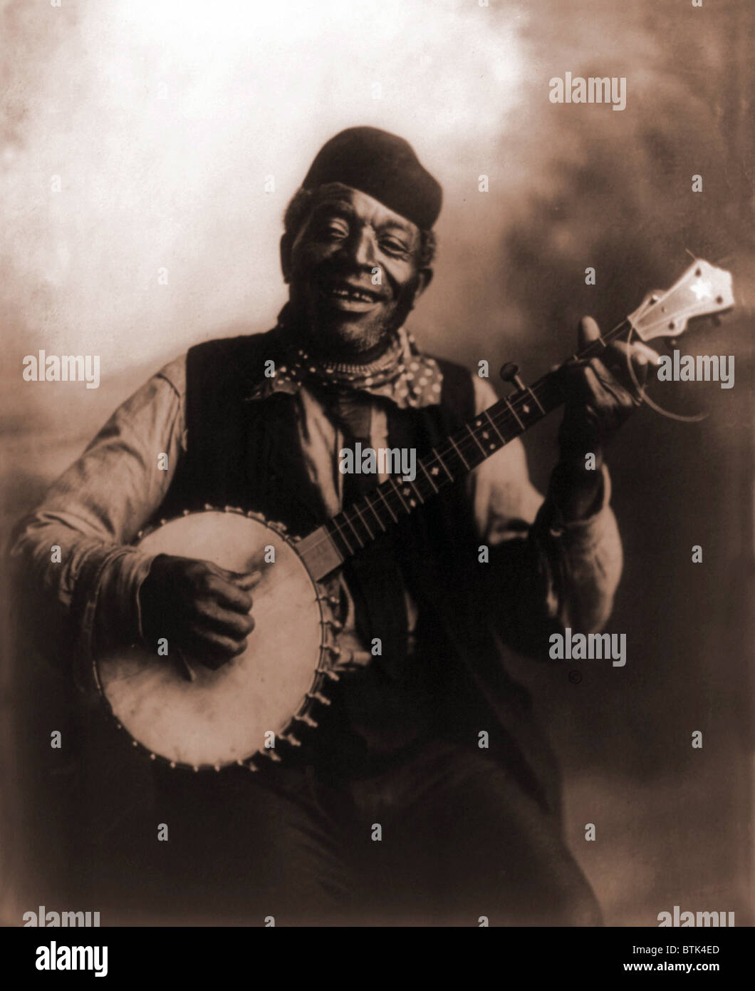African American man seated and holding banjo. Ca. 1911 Stock Photo - Alamy