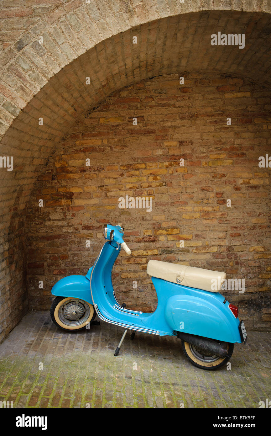 Baby blue vespa parked in a stone archway in Urbino Le Marche Italy ...