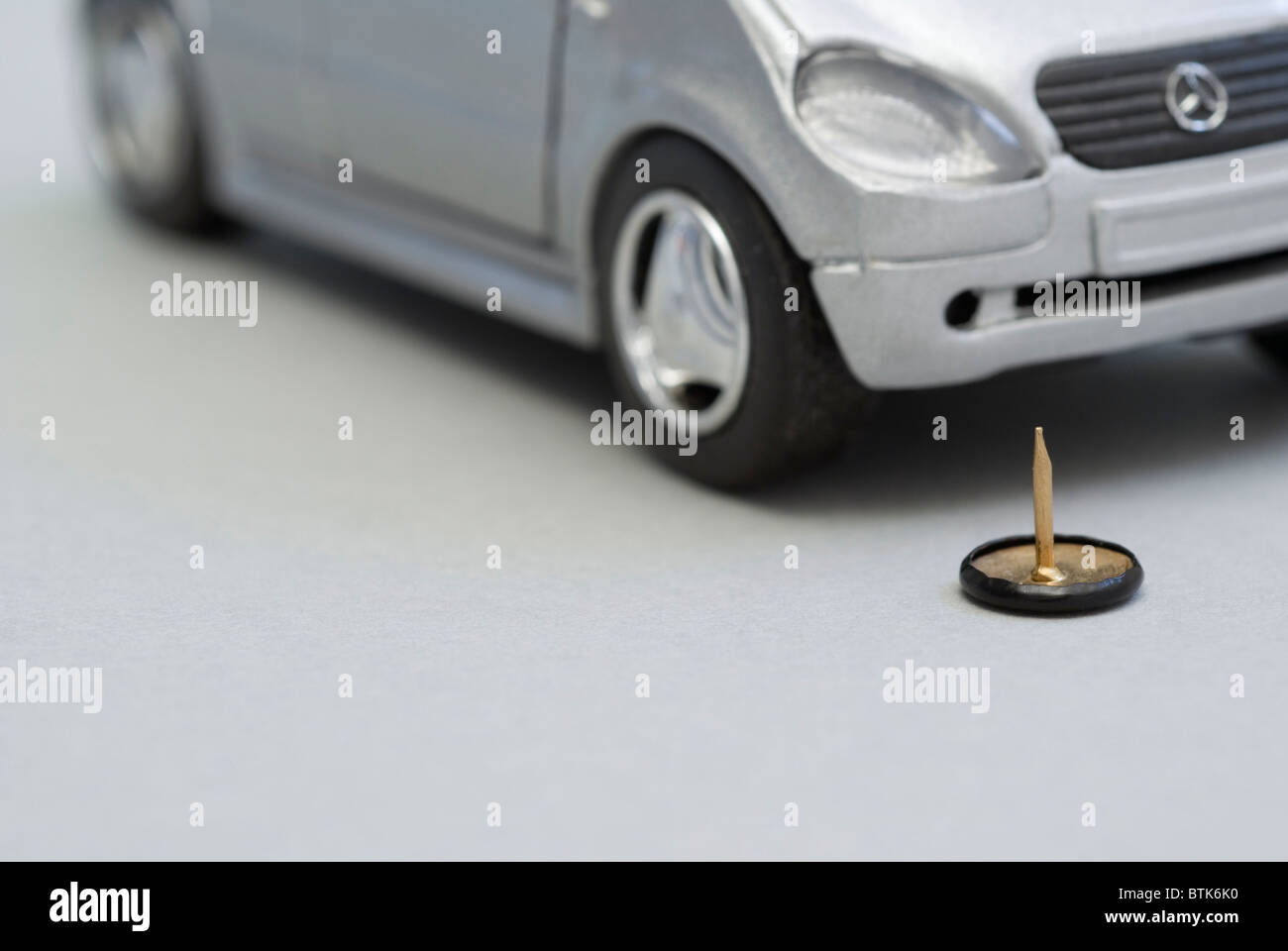 Drawing pin near car tyre Stock Photo - Alamy