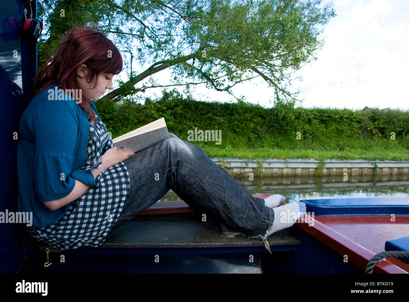 Reading in the Boat Stock Photo - Alamy