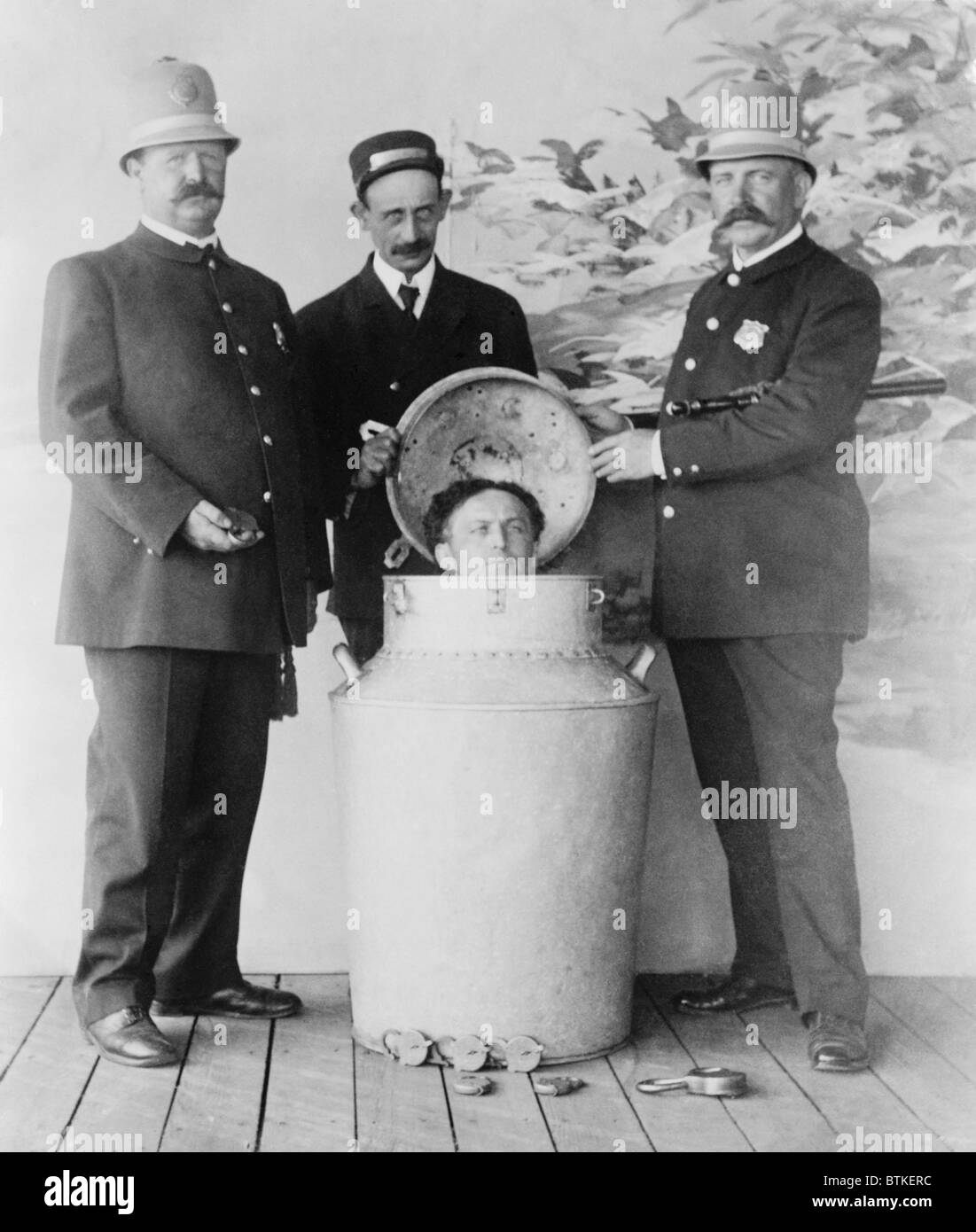 Harry Houdini performs the great milk can escape from a giant milk can ...