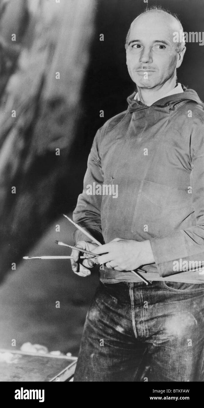 Rockwell Kent (1882-1971), American realist painter holding paint ...