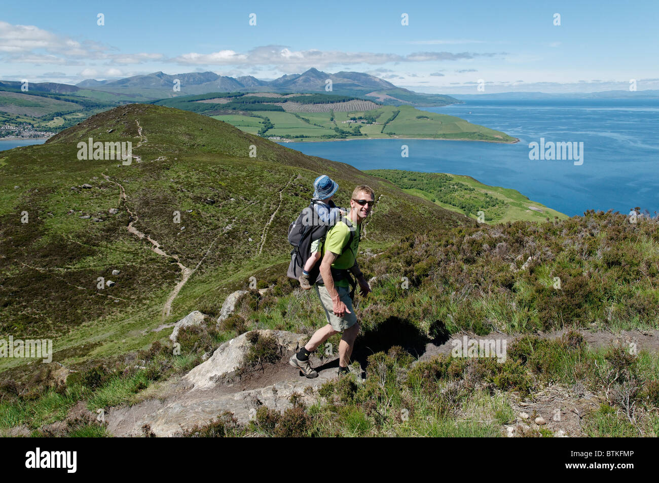 Father and son on the high peak of Mullach Mor, Holy Island, Arran ...