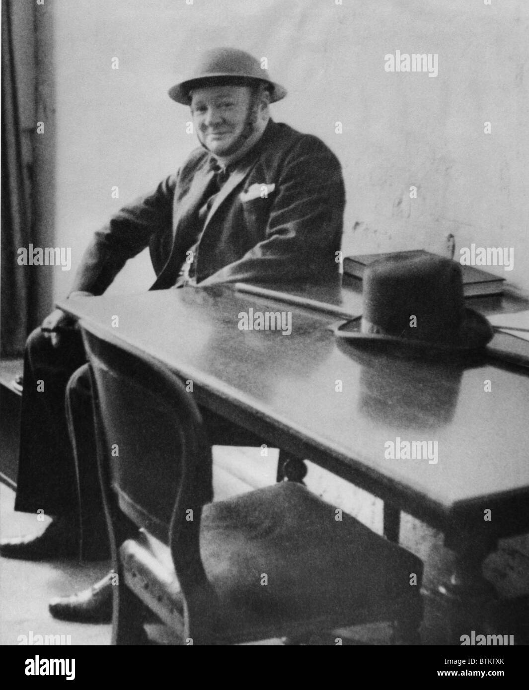 Winston Churchill (1874-1965), wearing a steel helmet during his visit ...