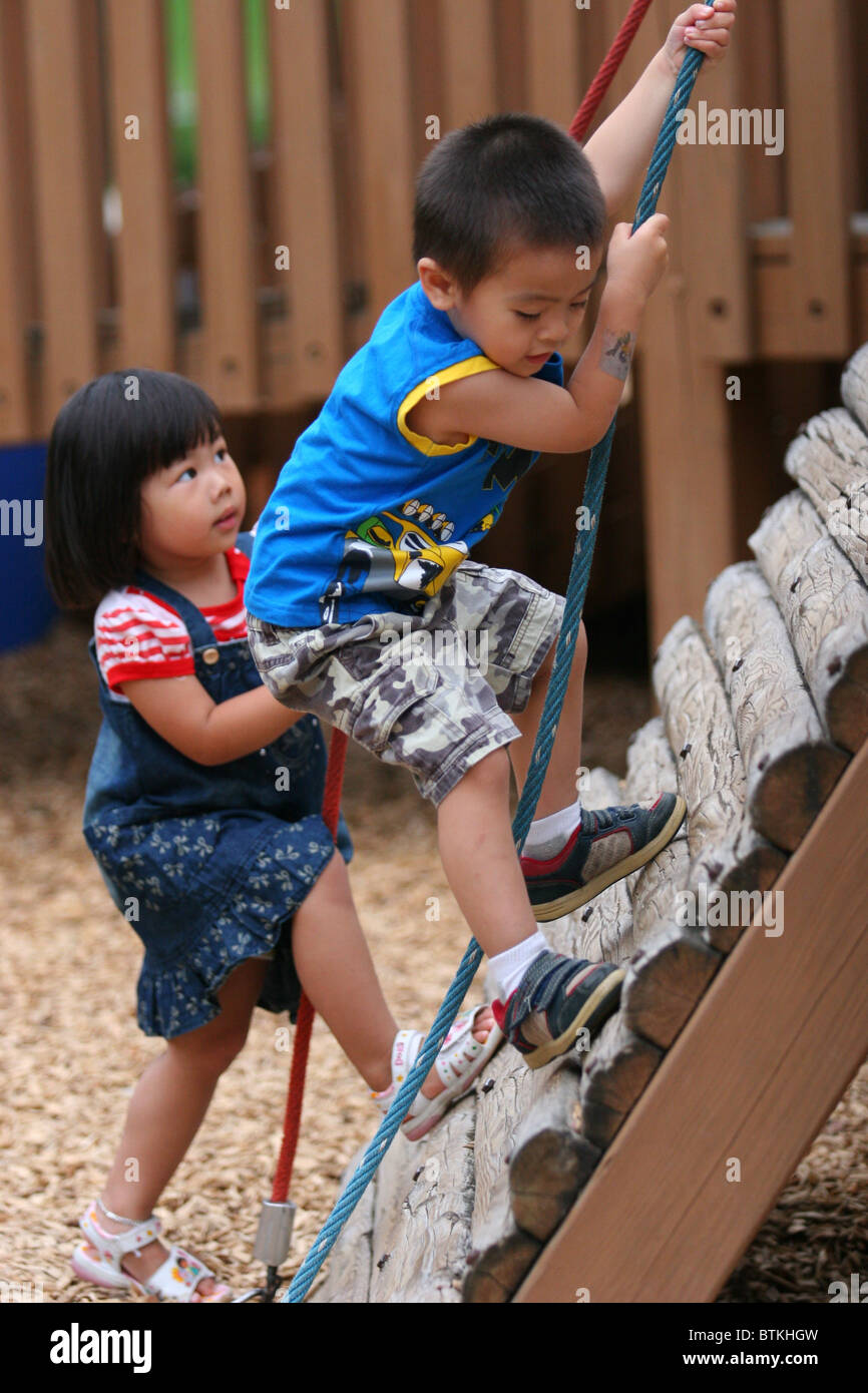 Two kids climbing up a ramp in Victoria park, Kitchener, Canada Stock ...