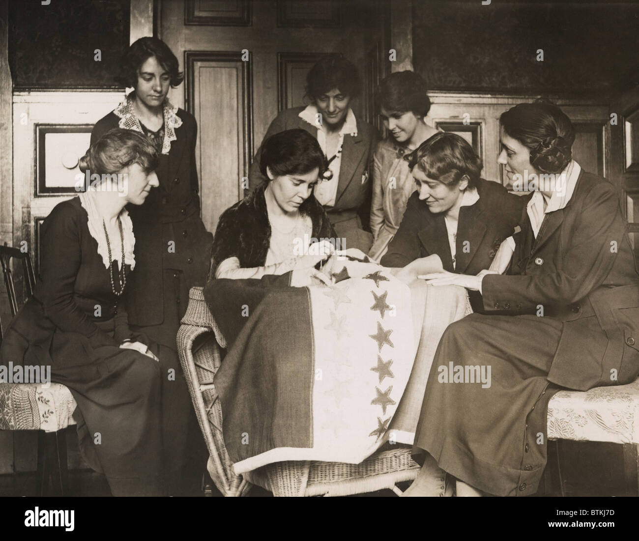 National Woman's Party activists watch Alice Paul sew a star onto the ...