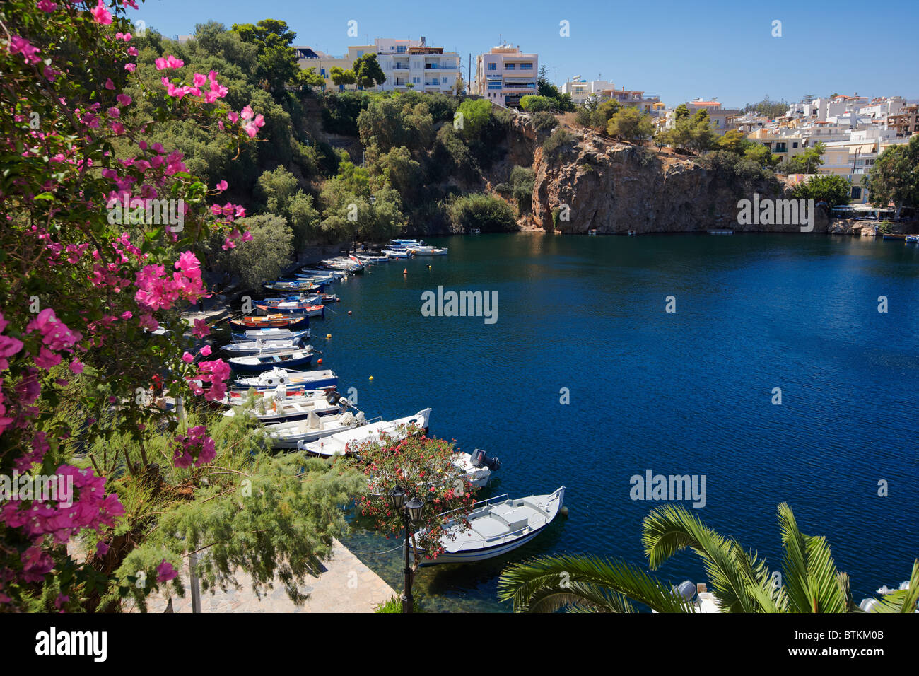 Aerial view of Lake Voulismeni with many boats moored at shore. Agios ...