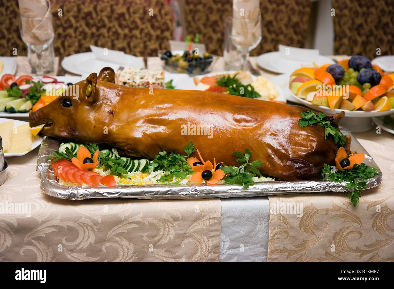 Photo of a fried pig on a dish on a table Stock Photo - Alamy