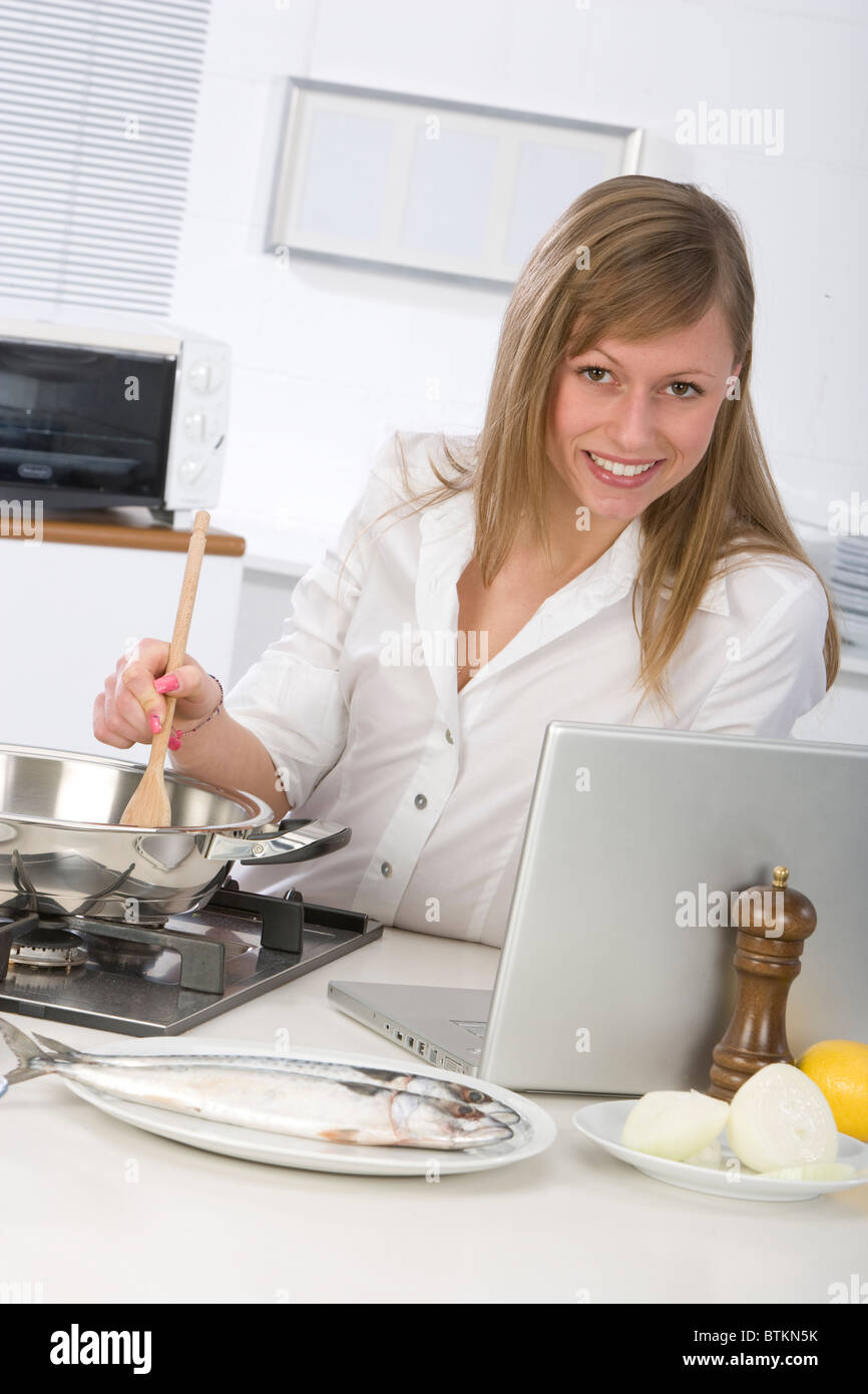 woman in the kitchen with computer Stock Photo - Alamy