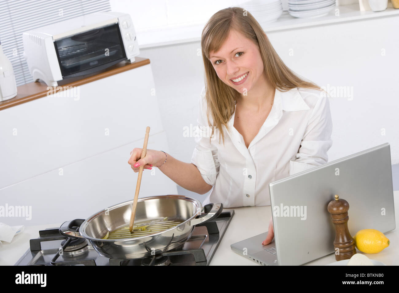 woman in the kitchen with computer Stock Photo - Alamy
