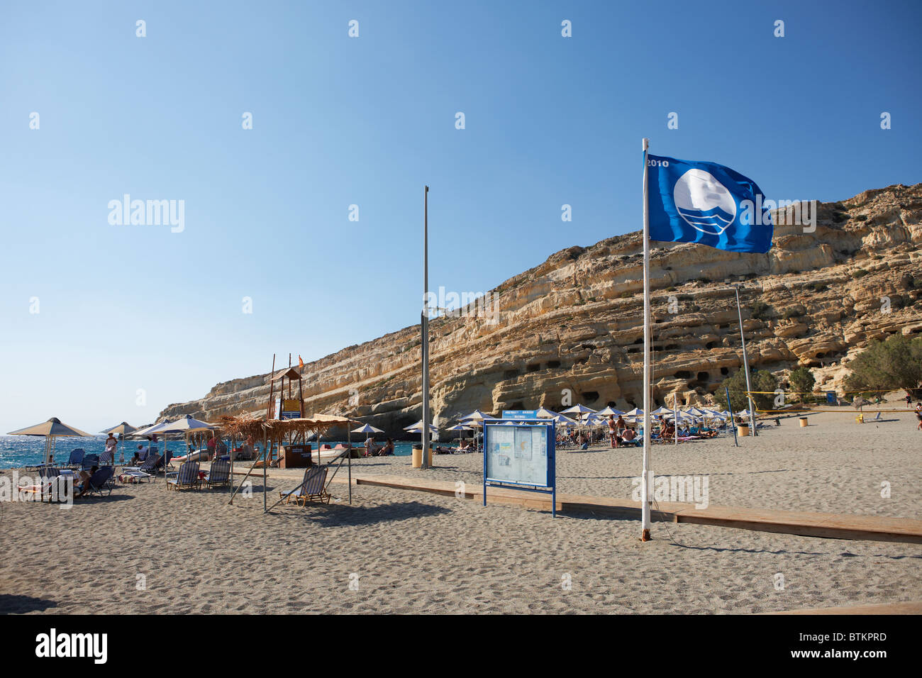 The Blue Flag on Matala Beach. Crete, Greece Stock Photo - Alamy