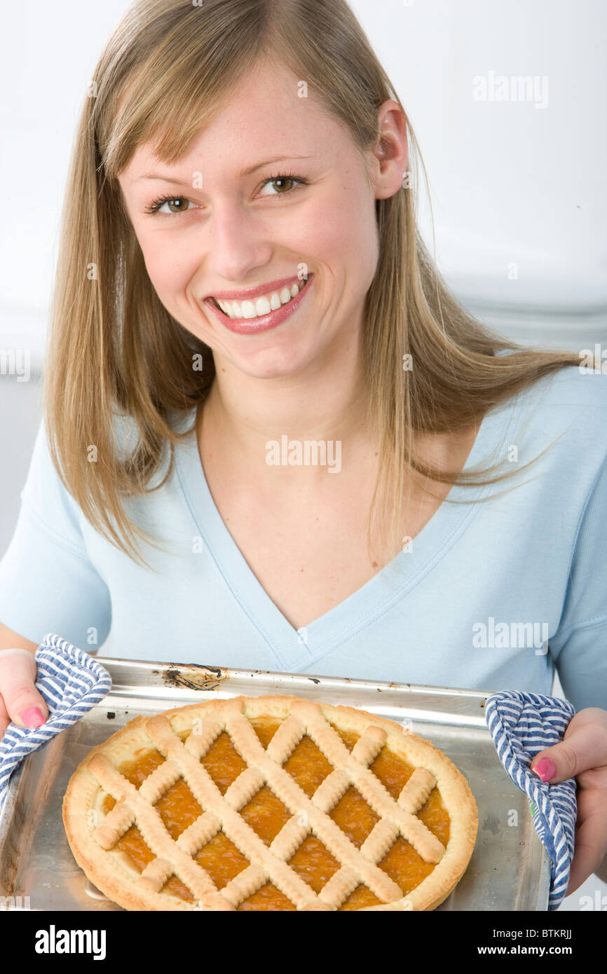 Beautiful woman in kitchen is making a cake Stock Photo - Alamy