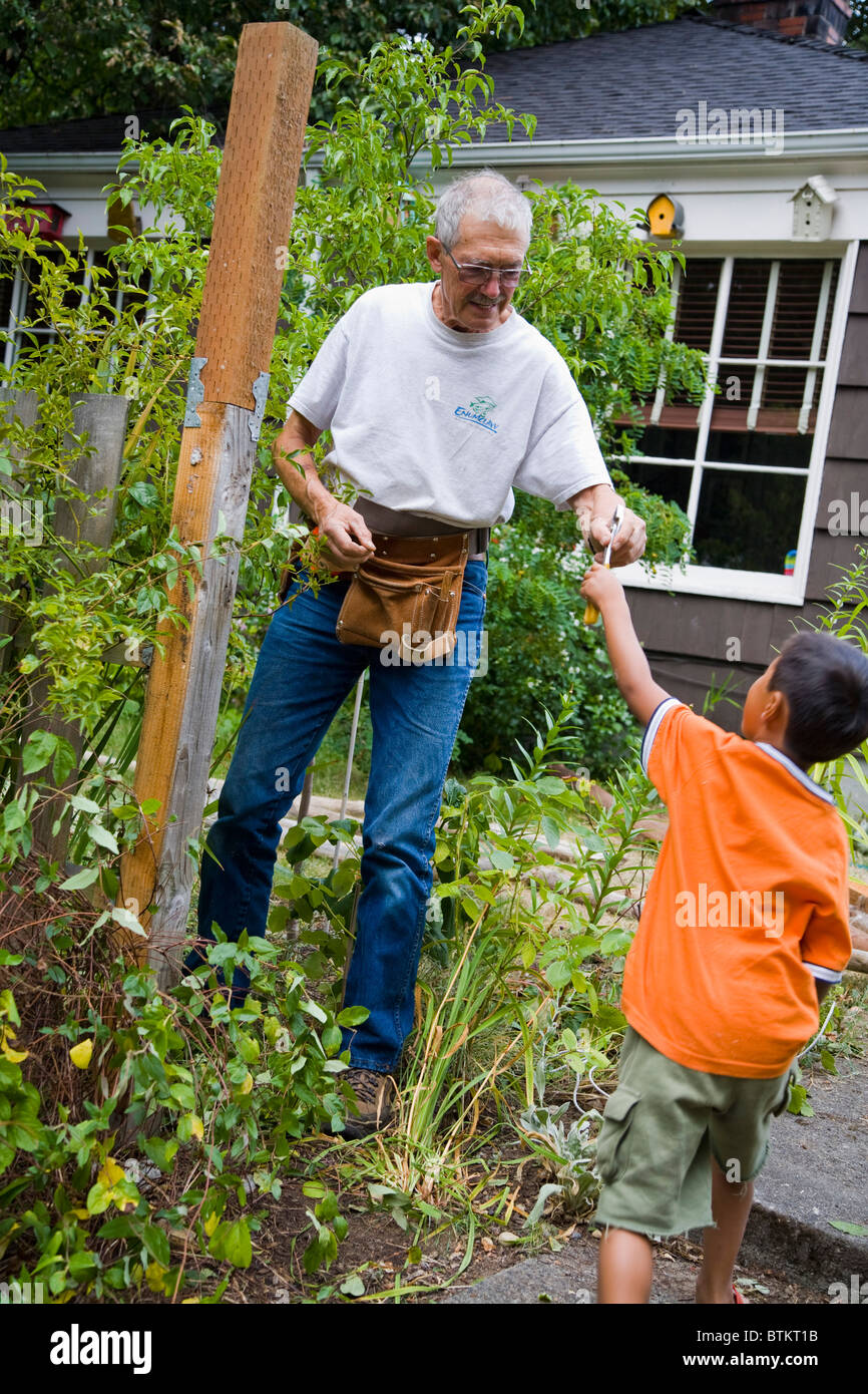 Child helping elderly person hi-res stock photography and images - Alamy