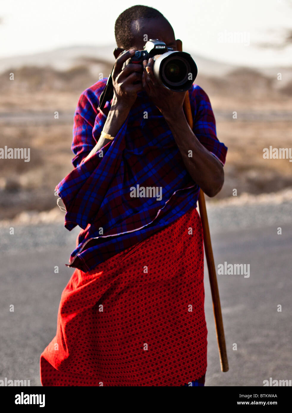 Masai tribesman shooting with a Nikon DSLR Stock Photo - Alamy