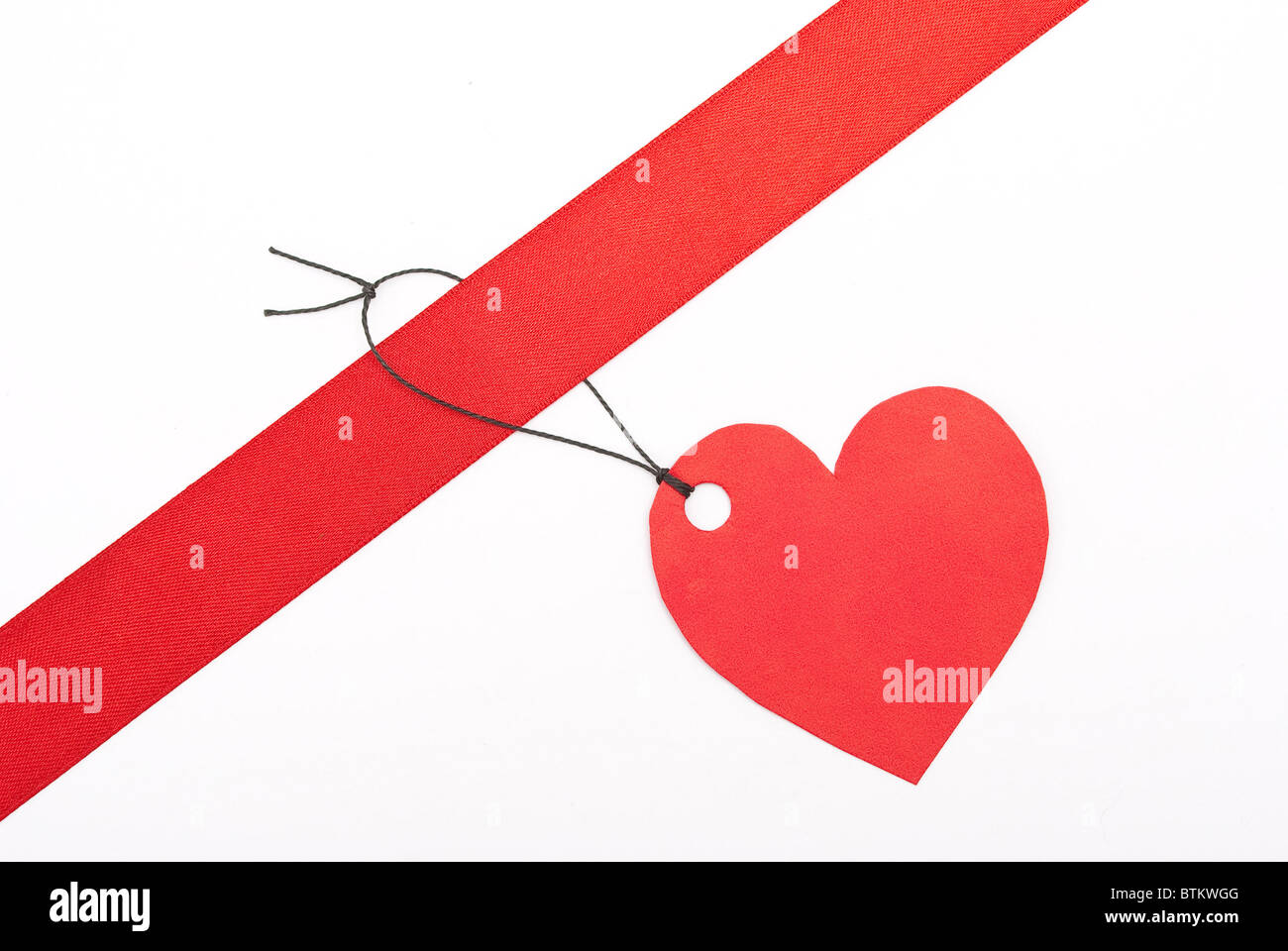 Red gift tag "heart"and ribbon Stock Photo - Alamy