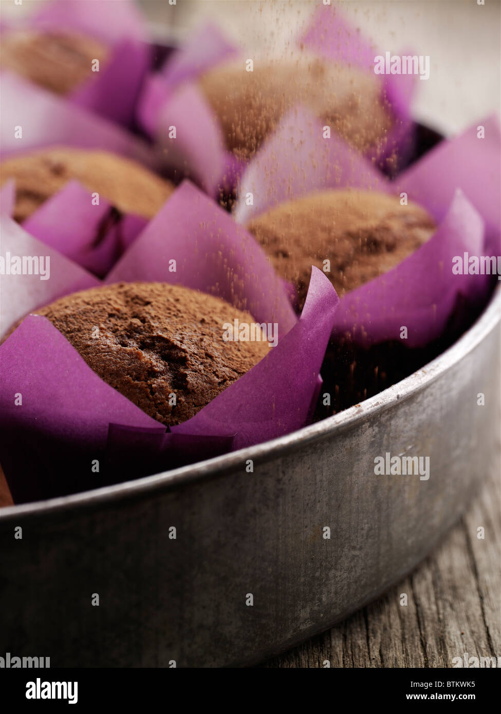 Fresh baked chocolate cupcakes in purple wrappers Stock Photo - Alamy