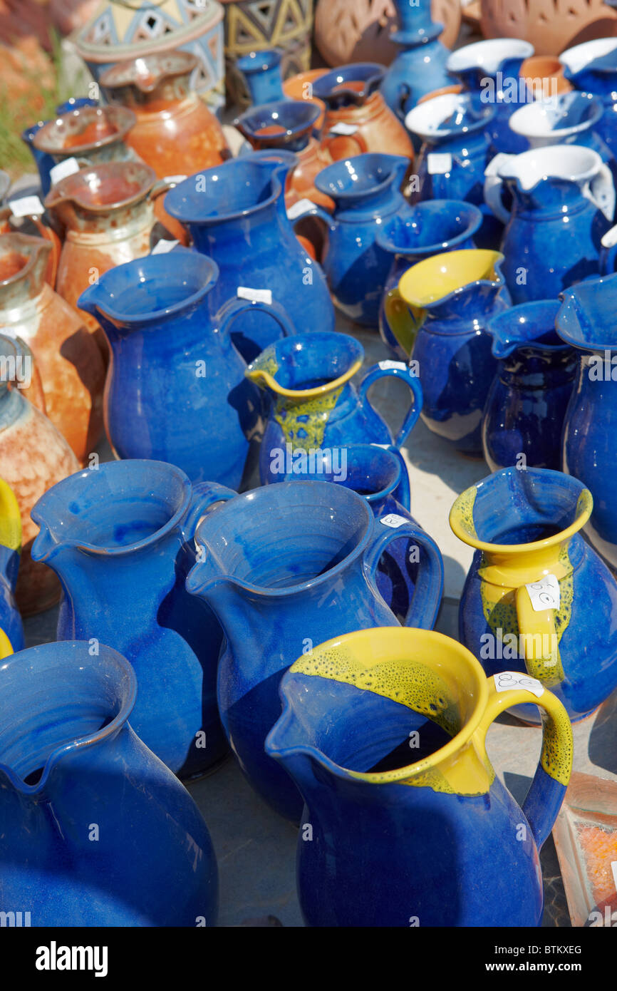 A selection of handmade ceramic jugs displayed at an outdoor pottery ...