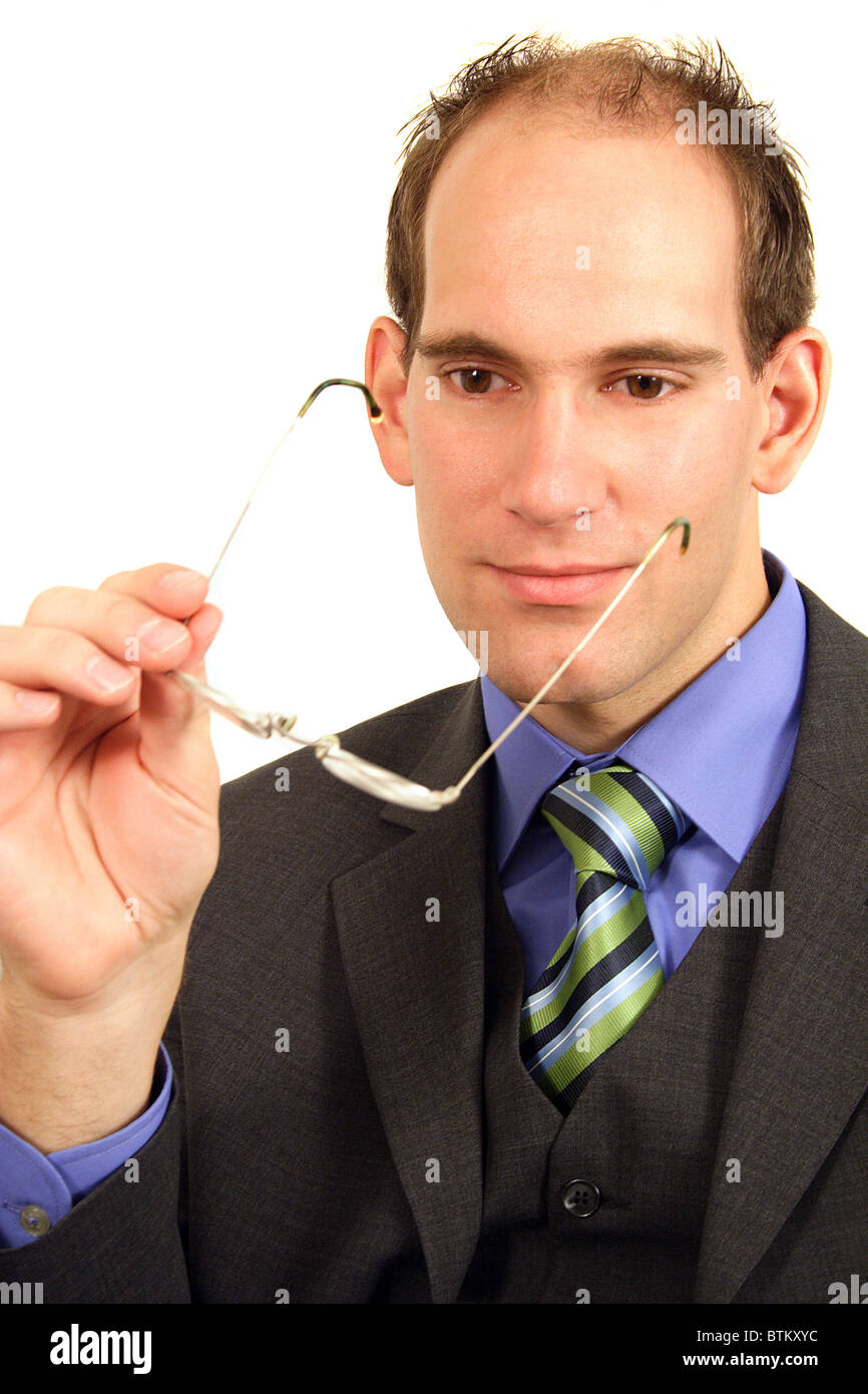 A businessman taking off his glasses. All isolated on white background ...