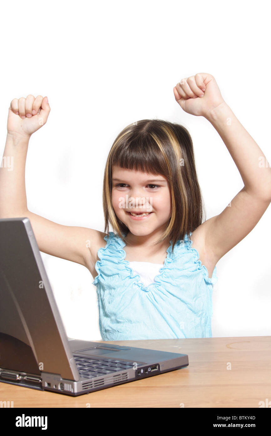 A young girl jubilating in front of her notebook computer. All isolated ...