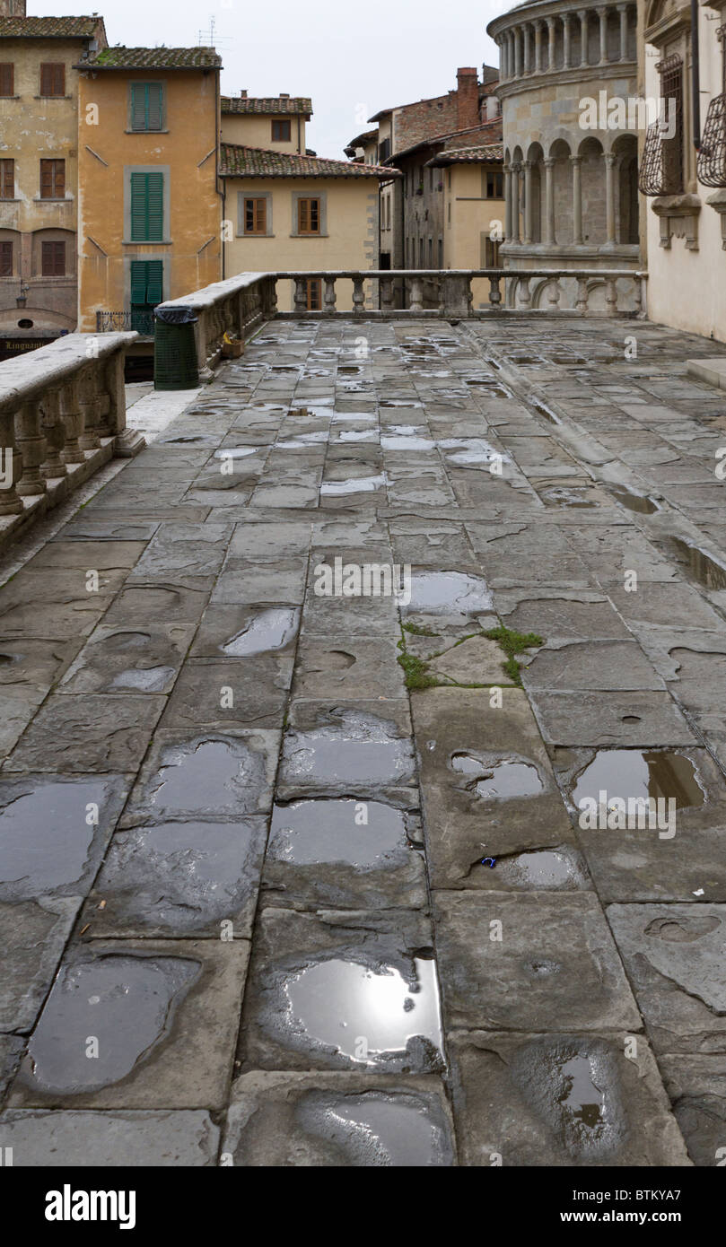 Reflection of the sun in puddles in worn paving stones at the Piazza ...