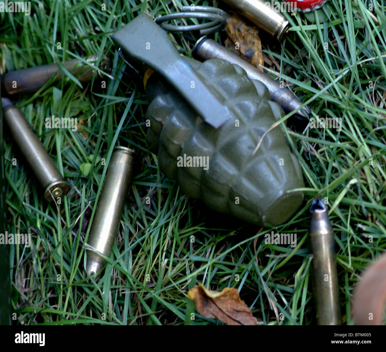 hand grenade sitting amongst spent bullets Stock Photo - Alamy